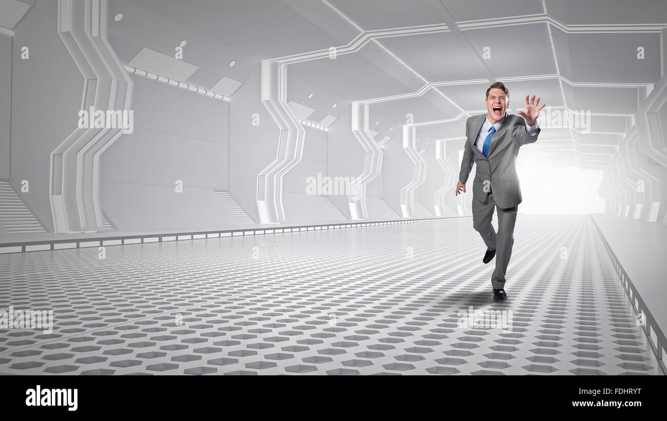 Young screaming businessman running in futuristic tunnel hi-res stock ...
