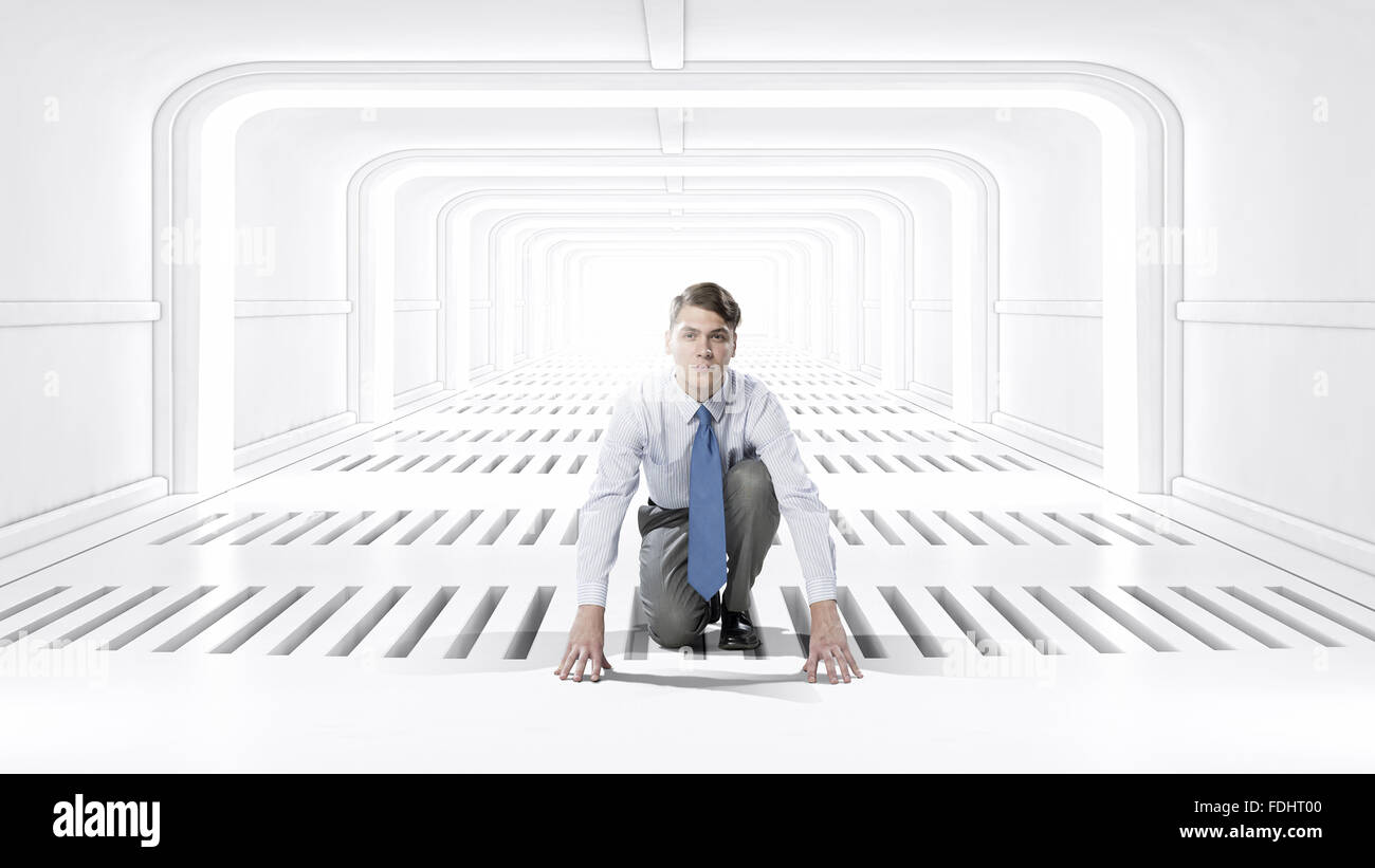 Young determined businessman standing in start position ready to ...