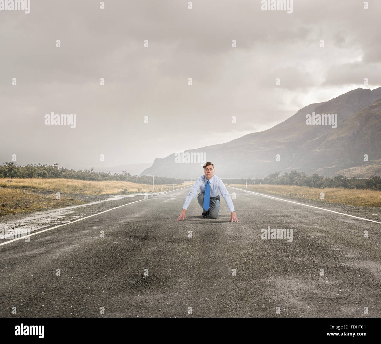 Young businessman standing in start position ready to compete Stock ...