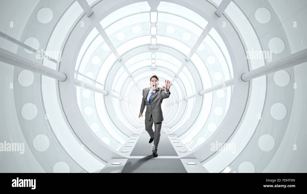 Young screaming businessman running in futuristic tunnel hi-res stock ...