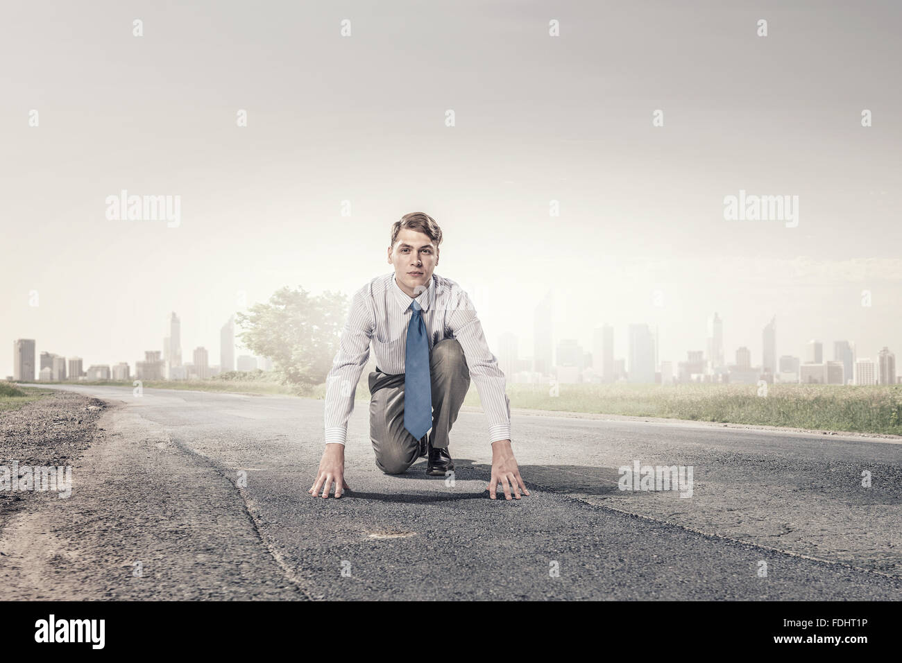 Young businessman standing in start position ready to compete Stock ...