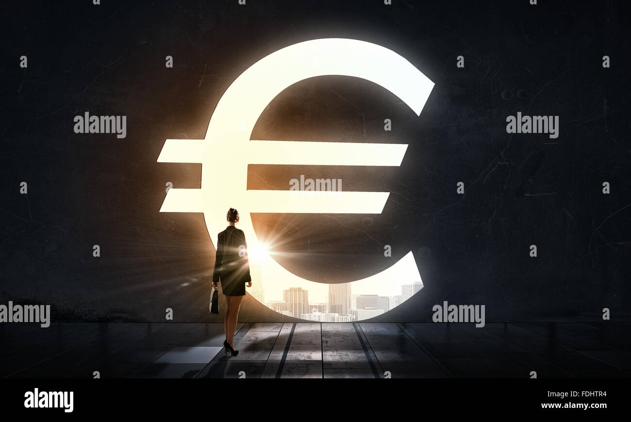 Silhouette of businesswoman in light of big euro symbol Stock Photo - Alamy