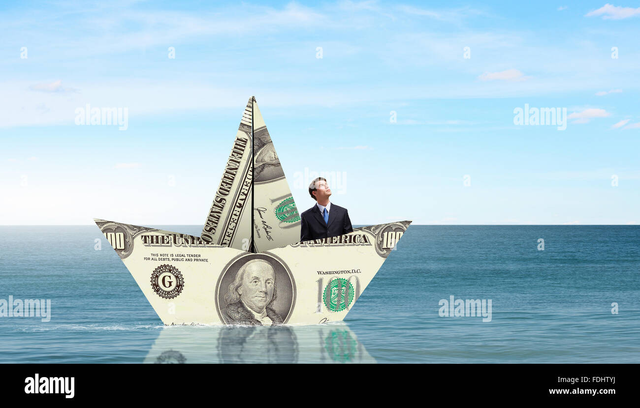 Successful businessman sailing on dollar boat in financial sea hi-res ...