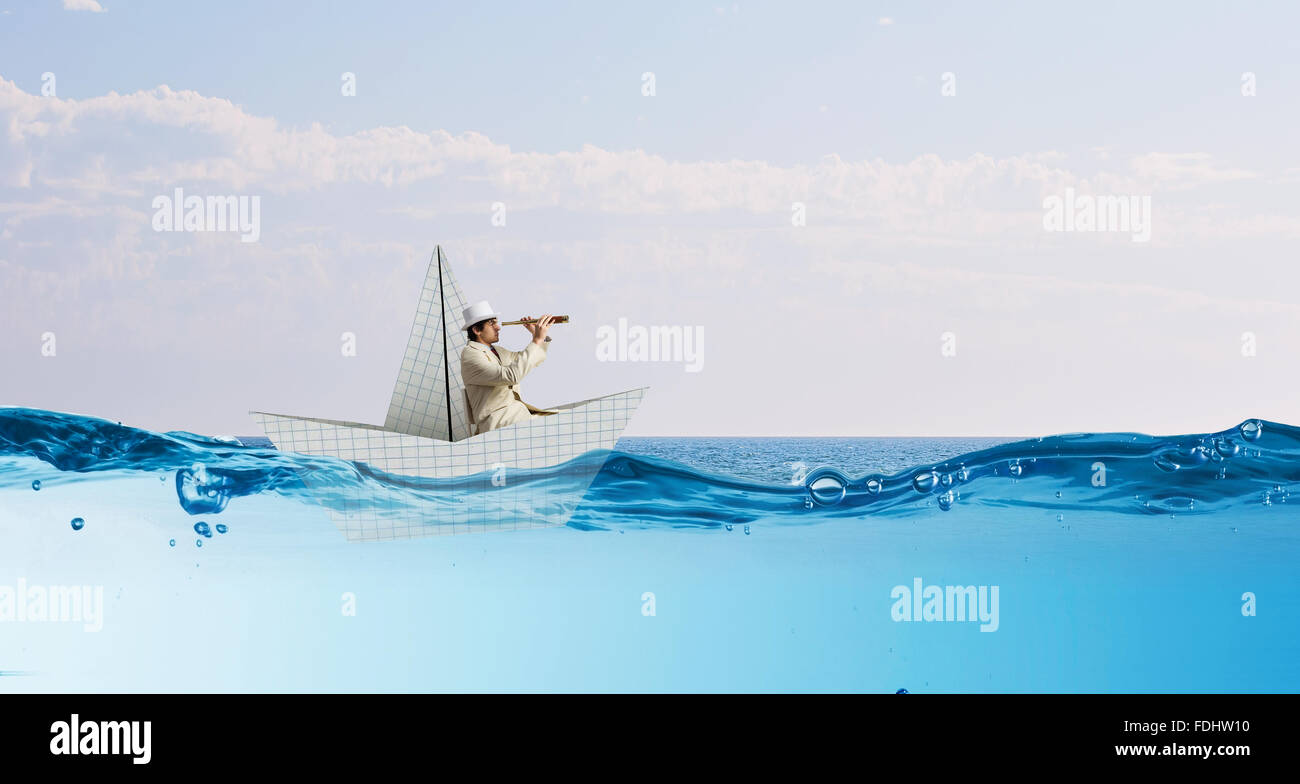 Successful businessman sailing on paper boat in financial sea Stock ...