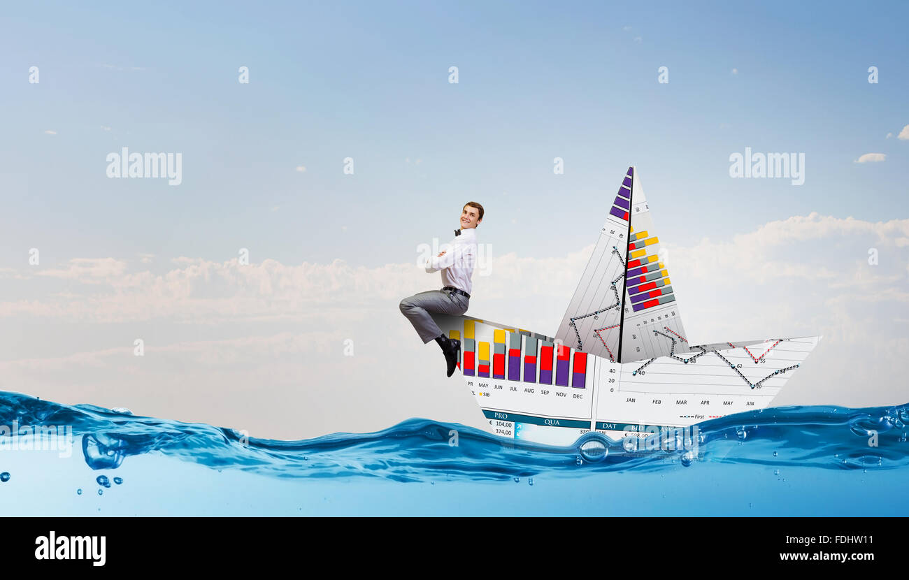 Successful businessman sailing on paper boat in financial sea Stock ...