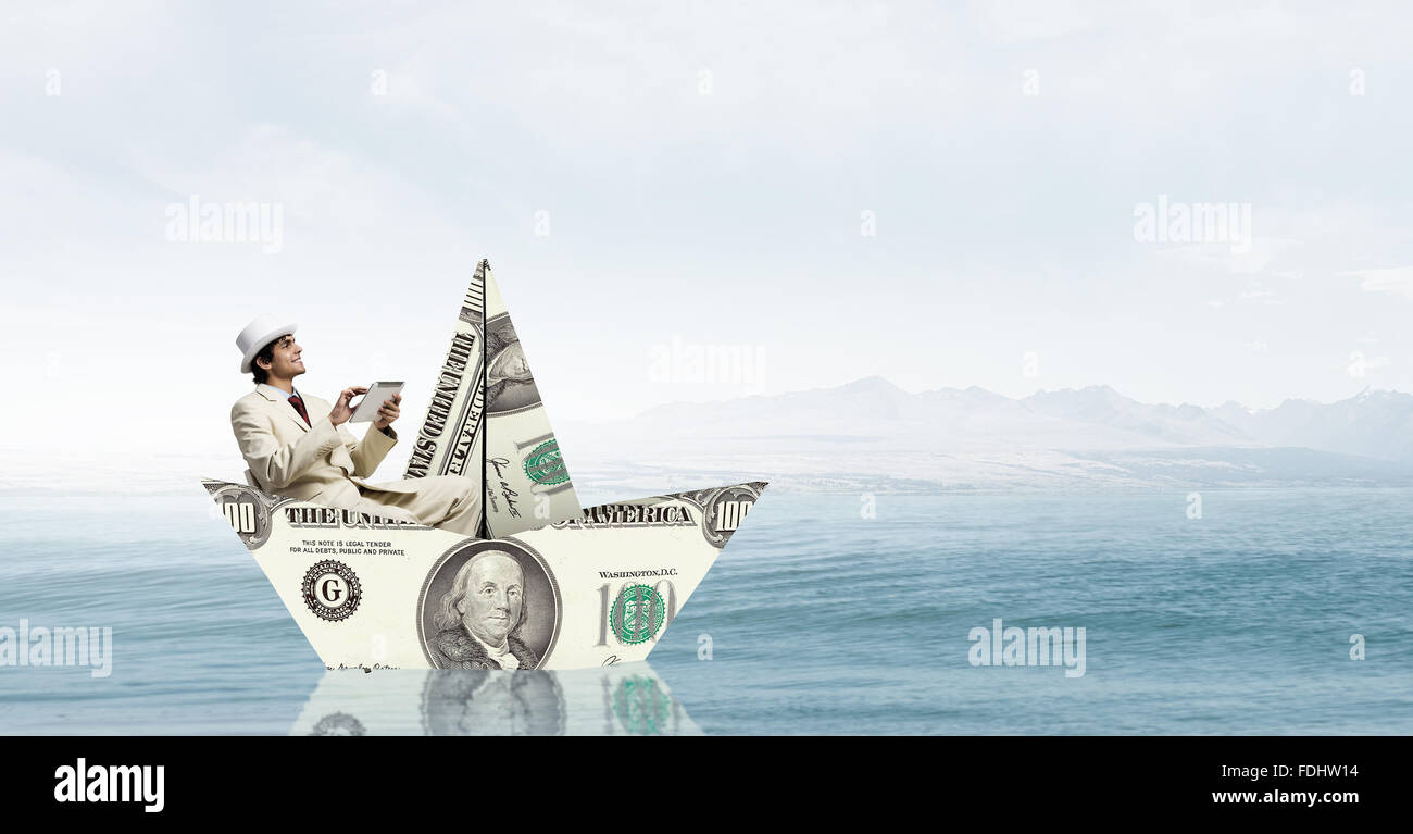 Successful businessman sailing on dollar boat in financial sea Stock ...