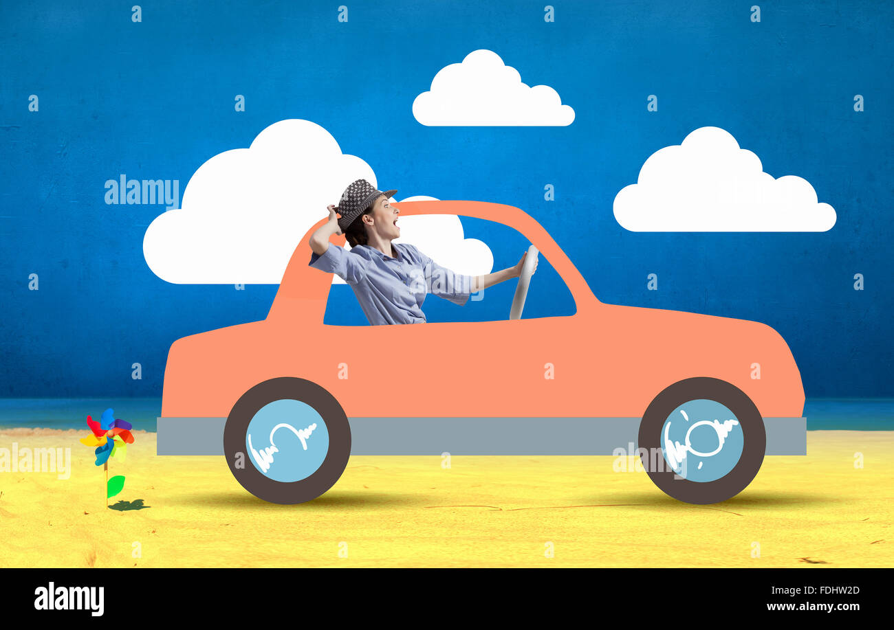 Young humorous woman driving drawn funny car Stock Photo - Alamy