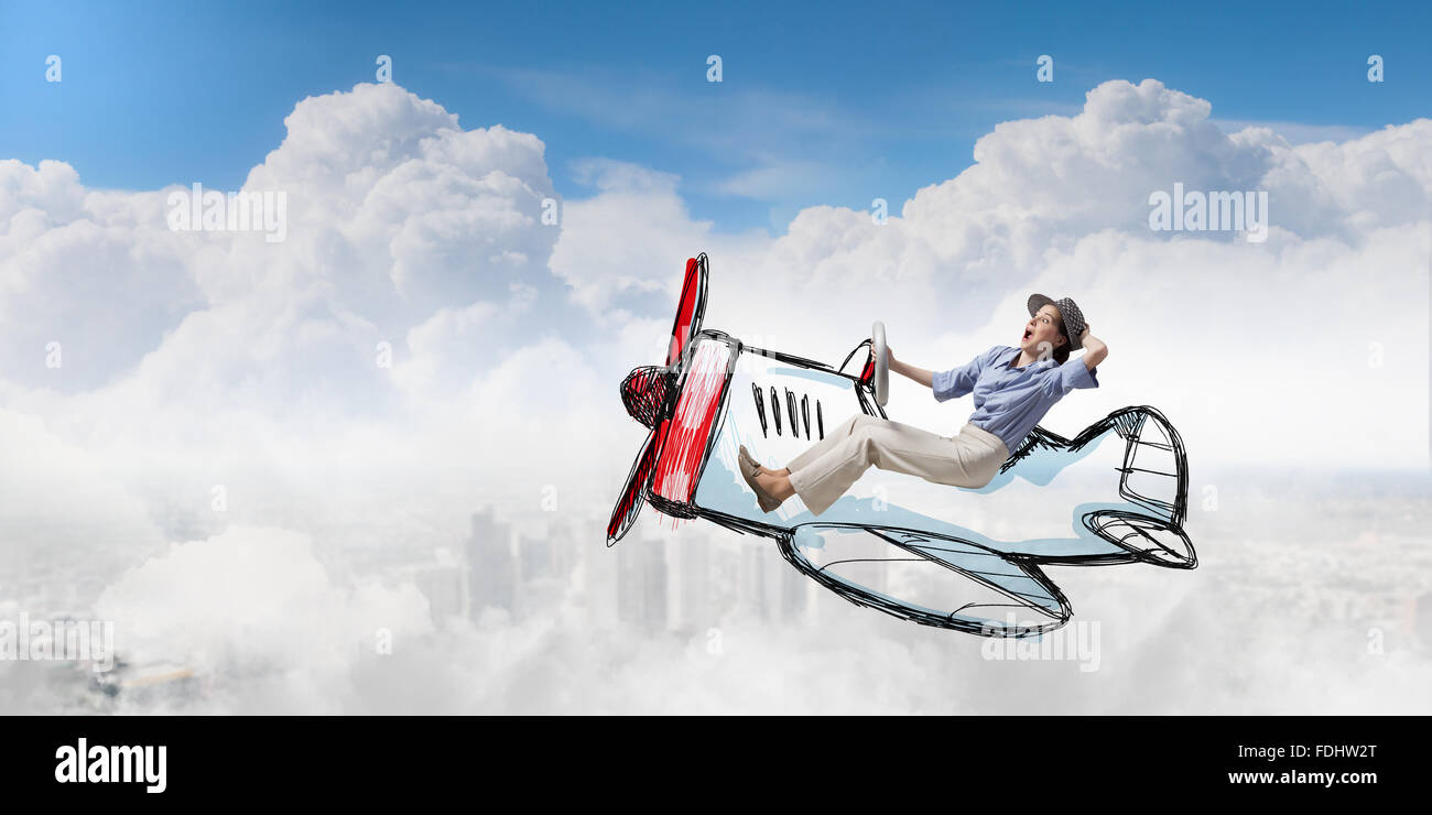 Young funny woman flying in air in drawn airplane Stock Photo - Alamy