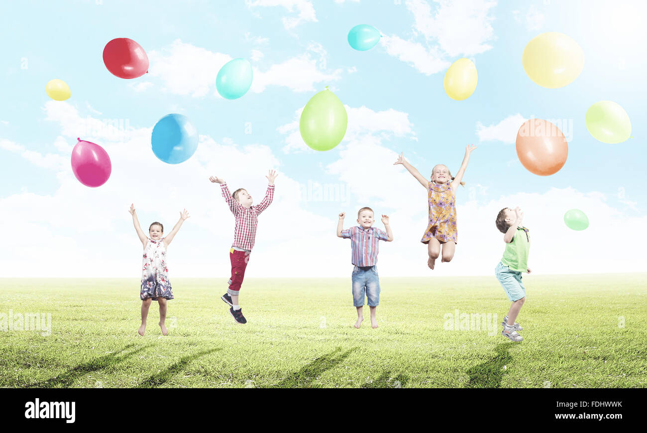 Group of happy children playing with colorful balloons Stock Photo - Alamy