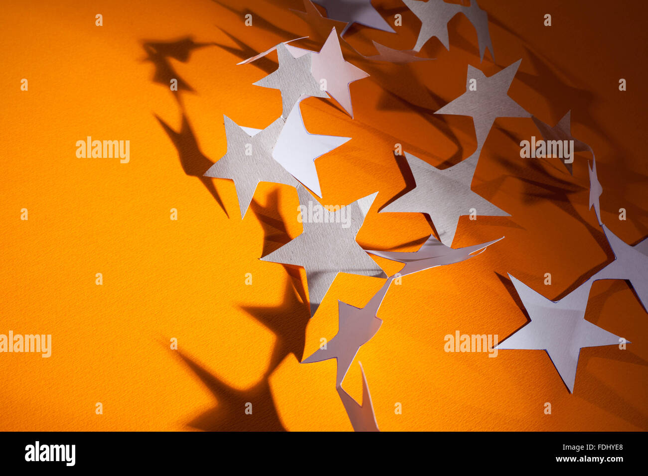 Paper stars group on a colour background Stock Photo - Alamy