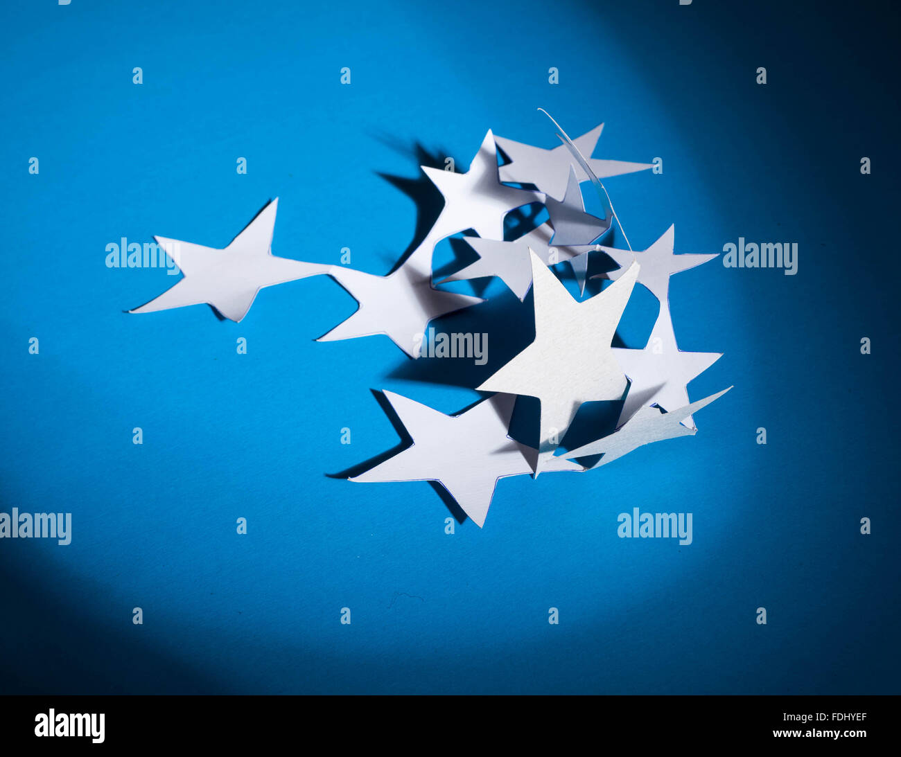 Paper stars group on a colour background Stock Photo - Alamy