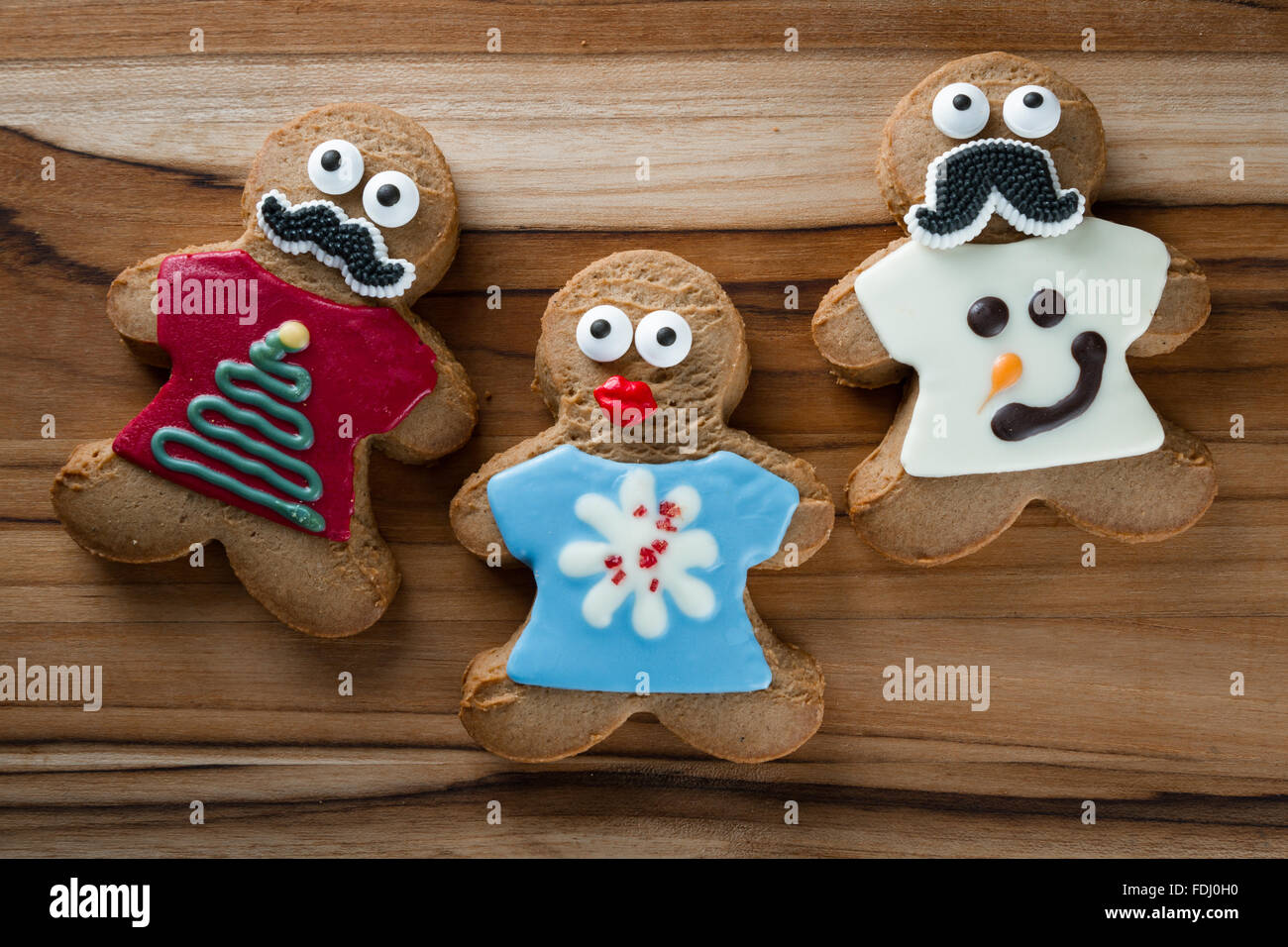 funny gingerbread cookies wearing ugly holiday sweaters and eyes and a ...
