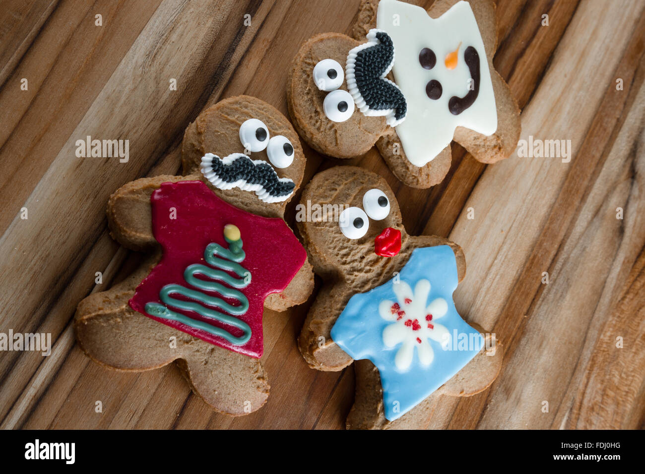 funny gingerbread cookies wearing ugly holiday sweaters and eyes and a ...
