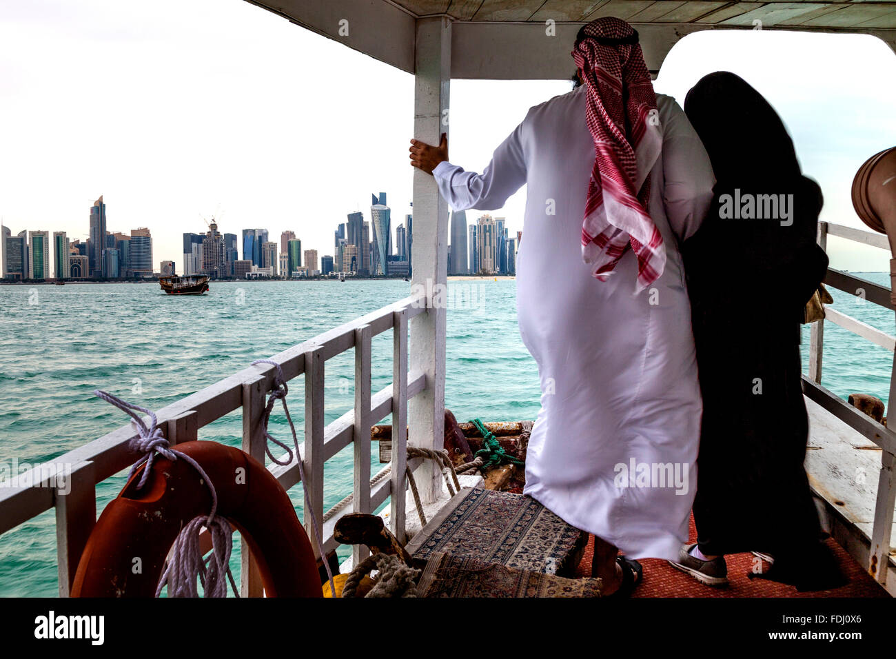 A Qatari Couple On A Dhow Cruise Around The Bay, Doha, Qatar Stock ...