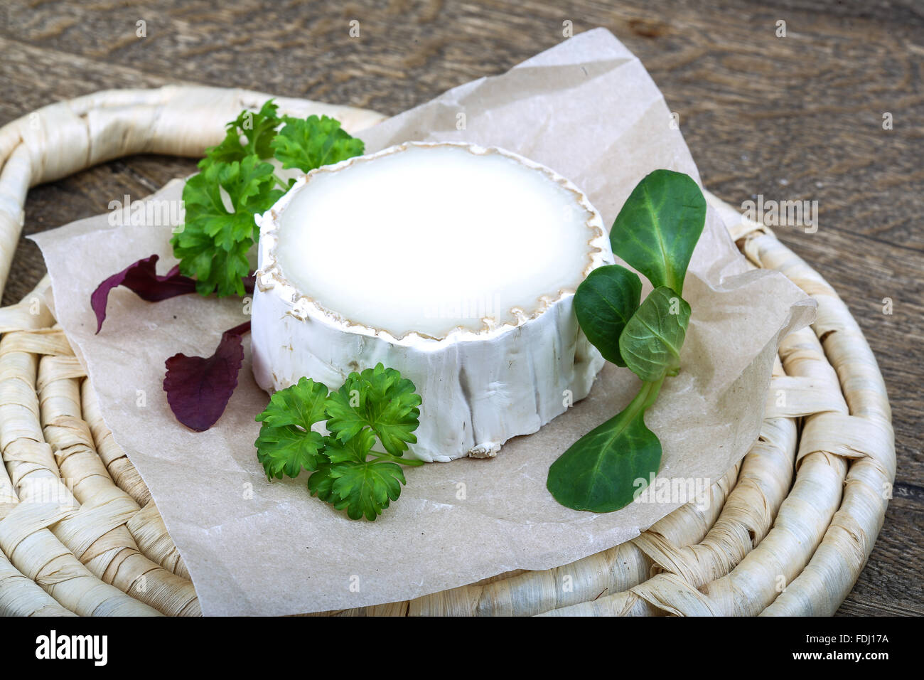 Goat cheese with white mold served parsley leaves Stock Photo - Alamy