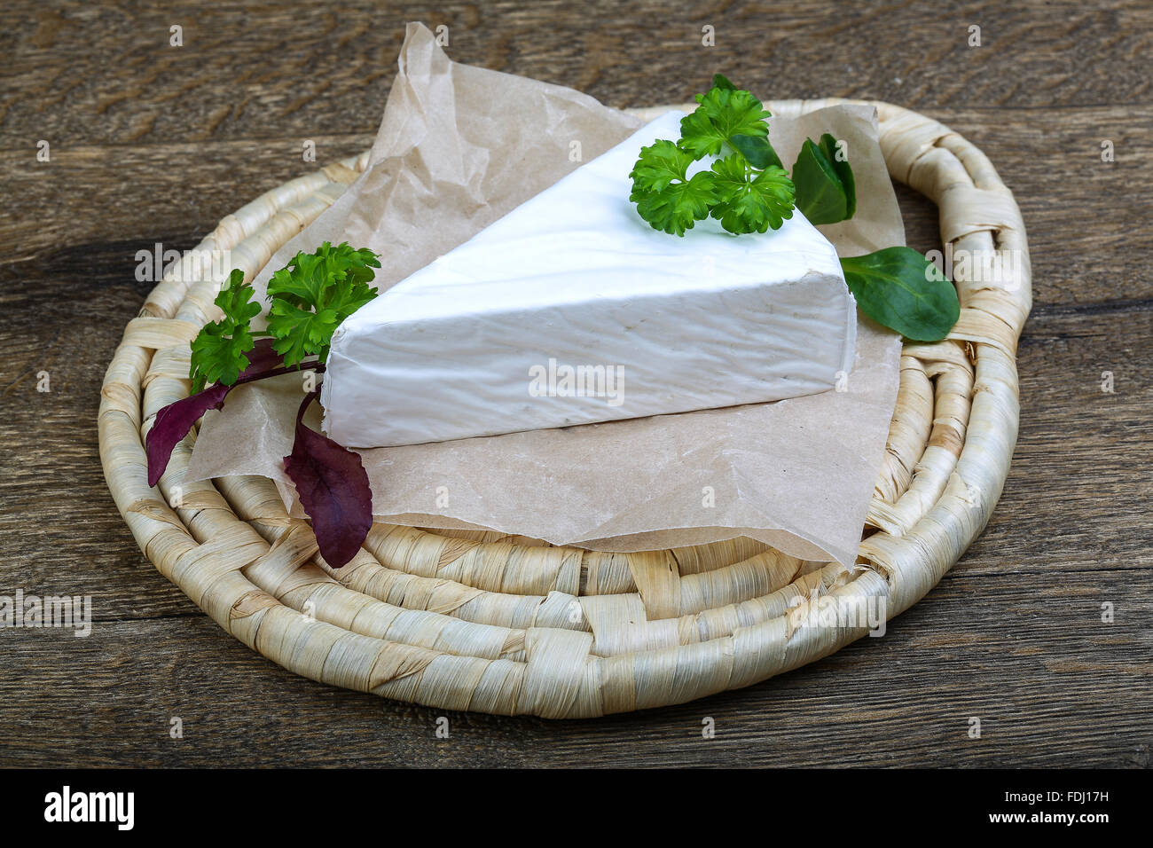 Soft brie cheese served parsley leaves on wooden background Stock Photo ...