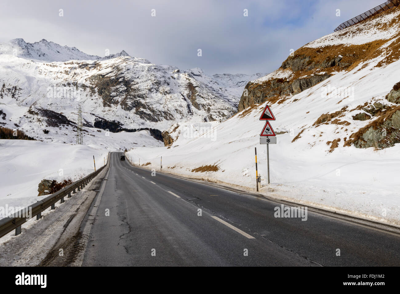 street signs on the Julier pass road in winter mountain landscape ...