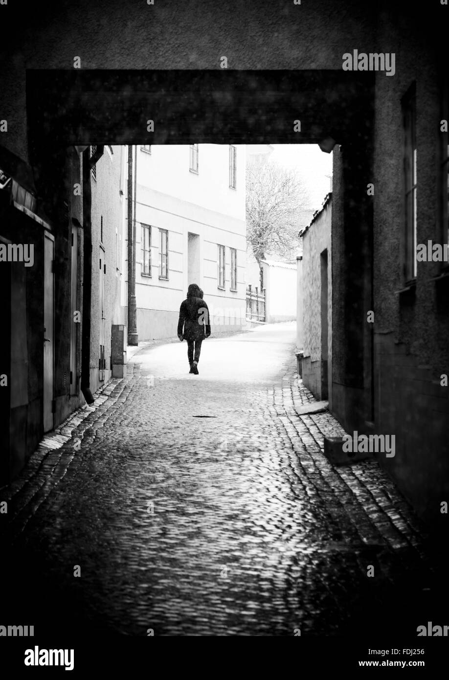 Person Walking in Alley in Visby, Gotland Stock Photo - Alamy