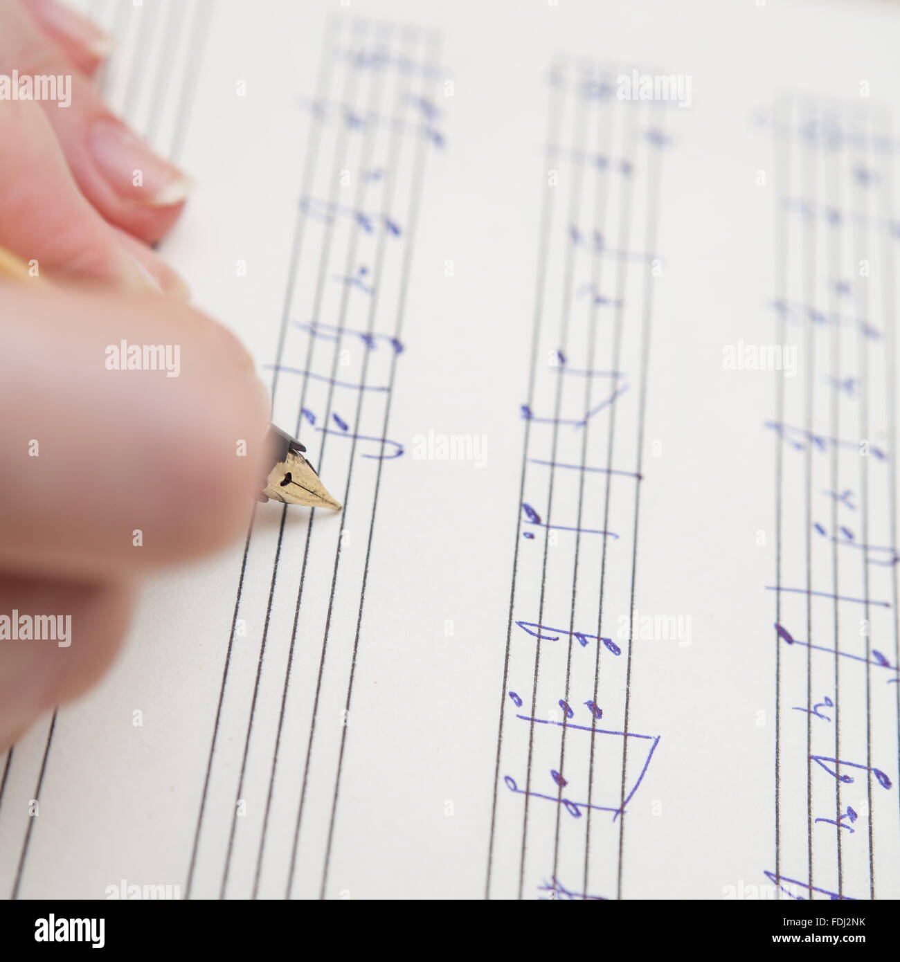 Hand with pen and music sheet Stock Photo - Alamy