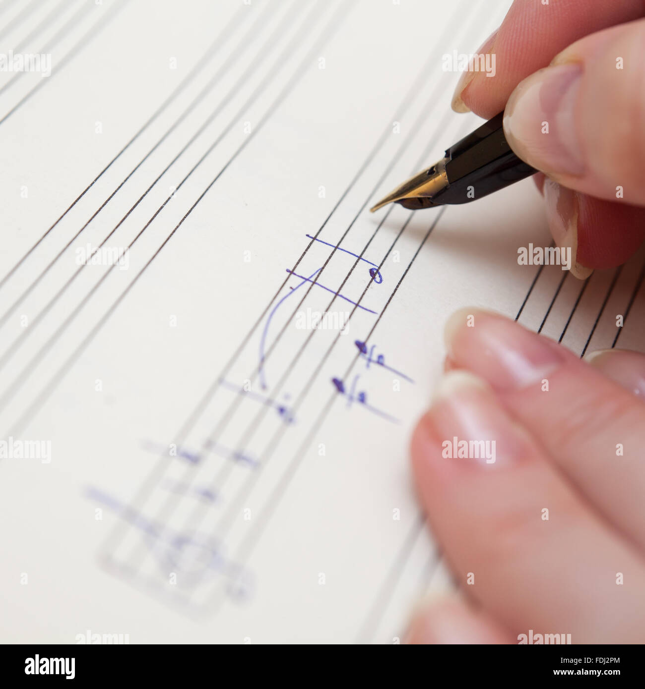 Hand with pen and music sheet Stock Photo - Alamy