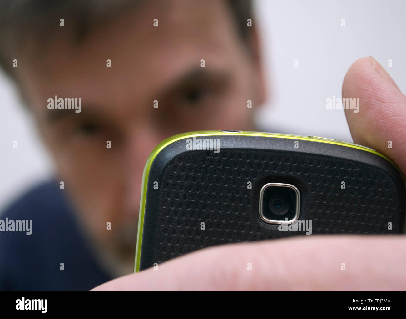man holding cameraphone Stock Photo - Alamy