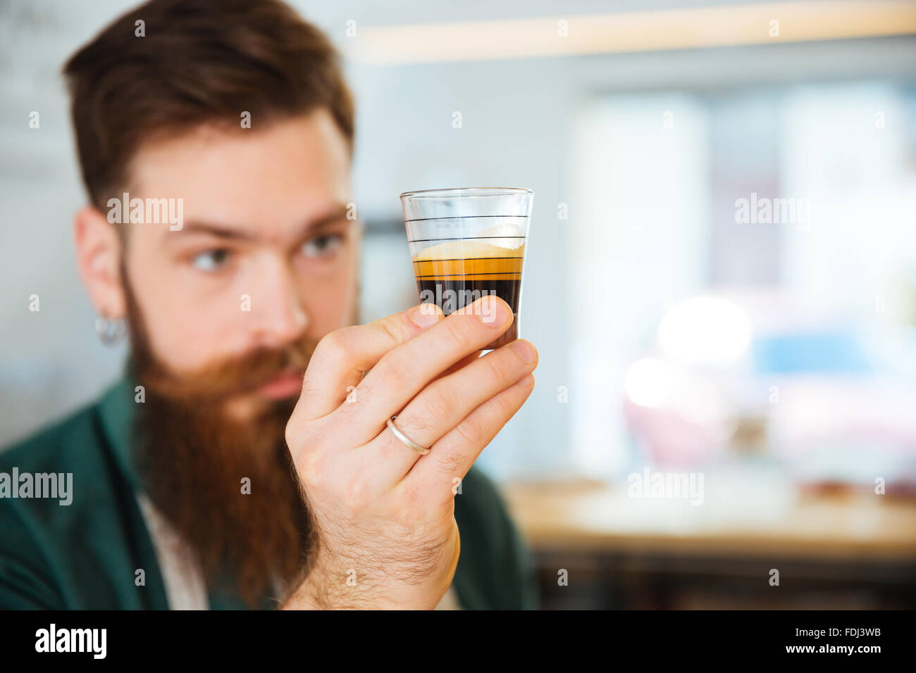 Barista holding glass with coffee in coffee shop. Focus on glass Stock ...