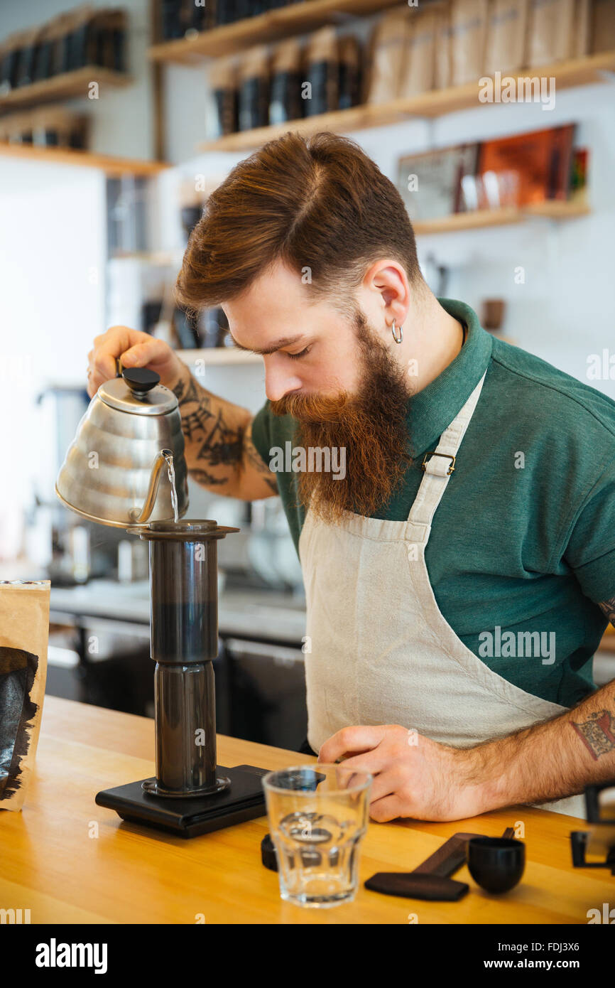 Barista pouring water on coffee ground with filter in coffee shop Stock ...