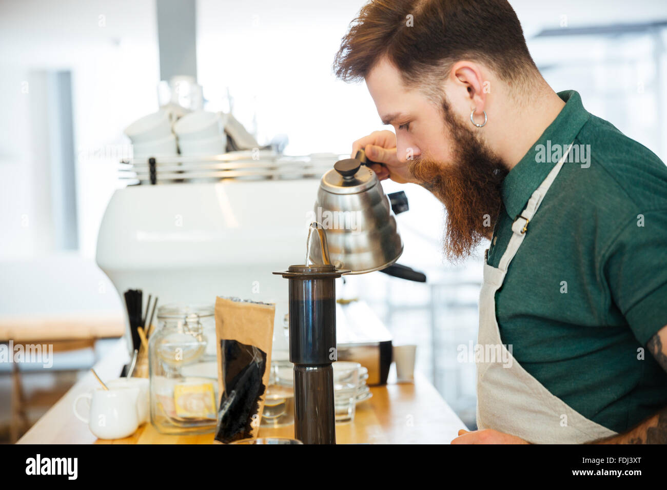Barista pouring water on coffee ground with filter in coffee shop Stock ...