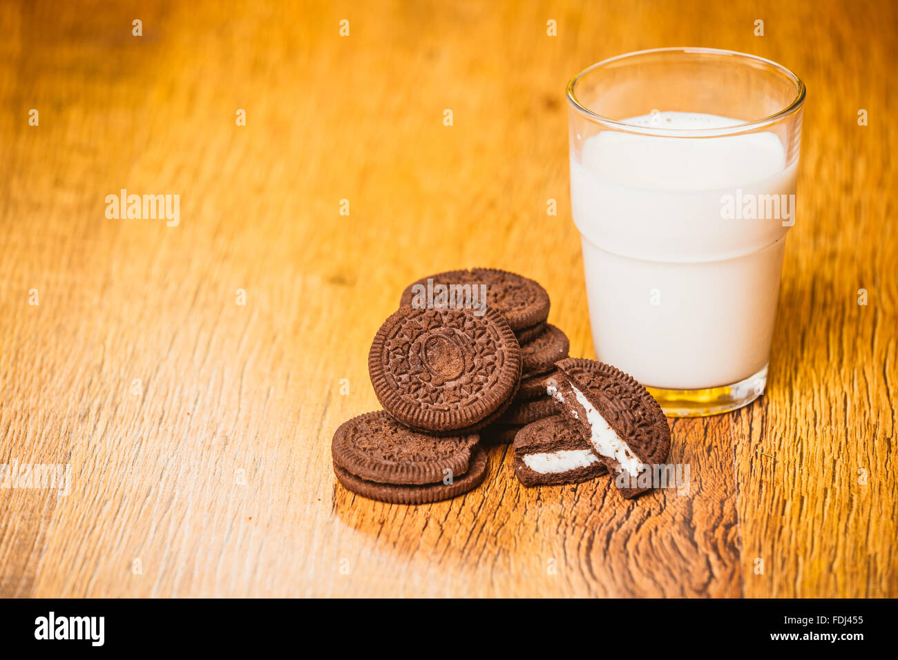 some dark glass of milk and cookies on a blurred background Stock Photo ...