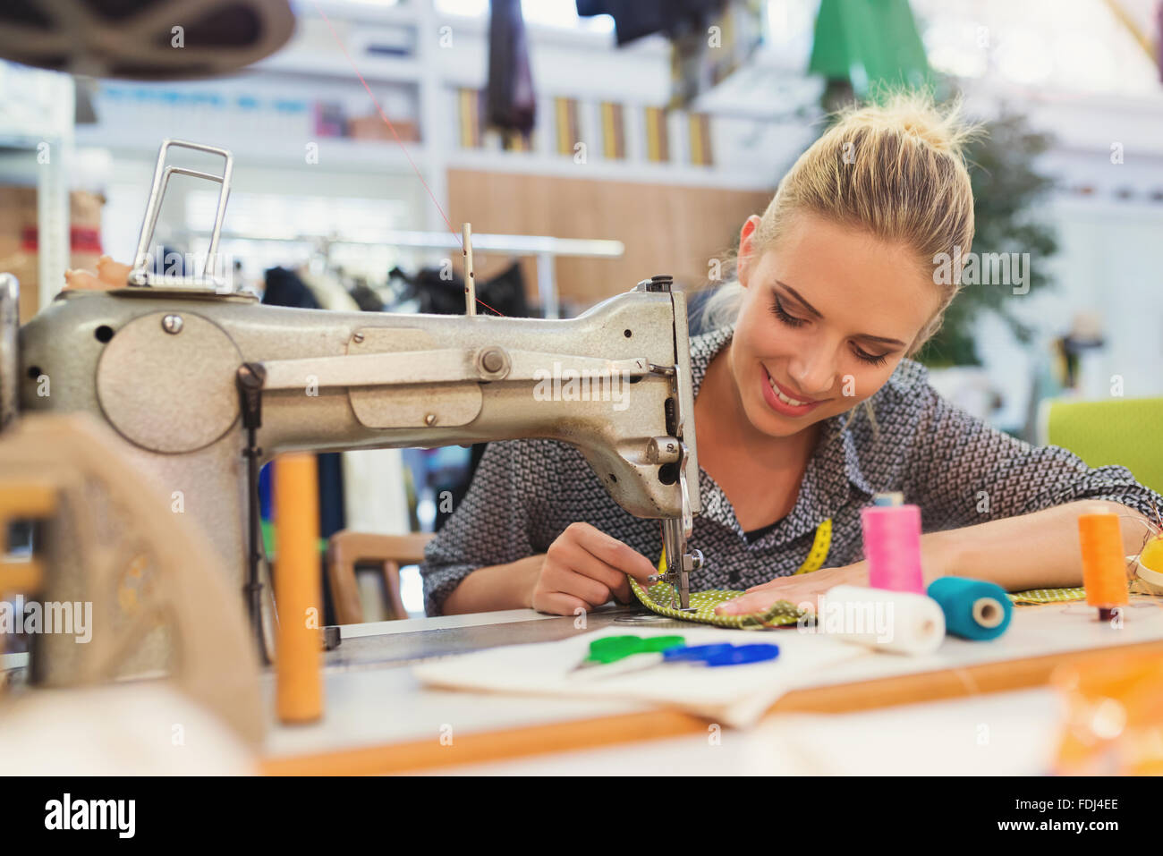 Young woman with sewing machine Stock Photo - Alamy