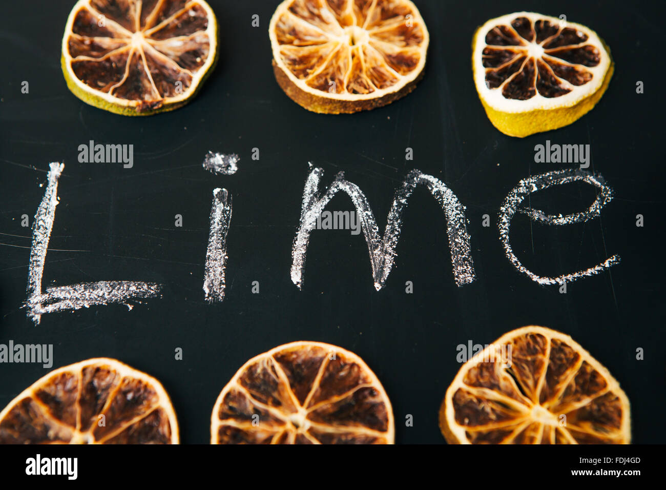 many cut orange circle on a black background board Stock Photo - Alamy