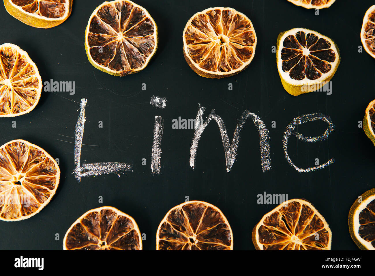 many cut orange circle on a black background board Stock Photo - Alamy