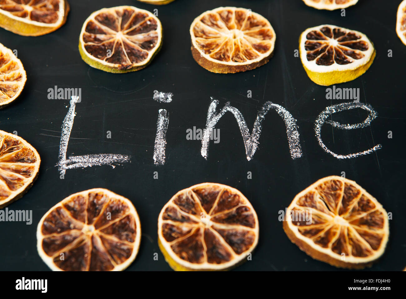 many cut orange circle on a black background board Stock Photo - Alamy