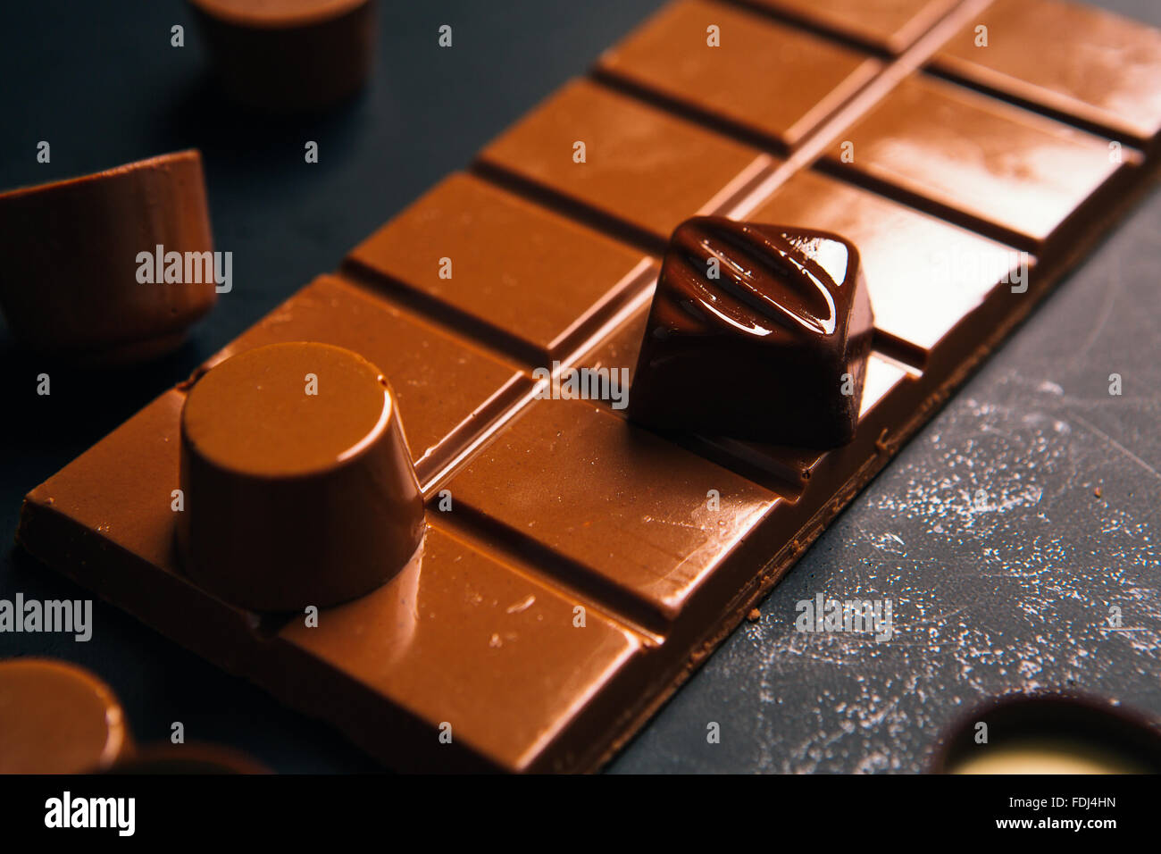 Many chocolate candy sweets on black background Stock Photo - Alamy