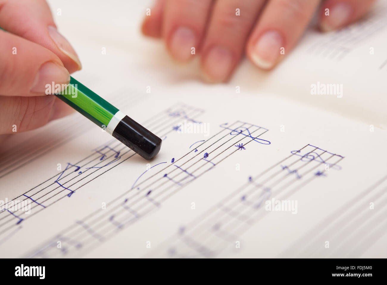Hand with pen and music sheet Stock Photo - Alamy