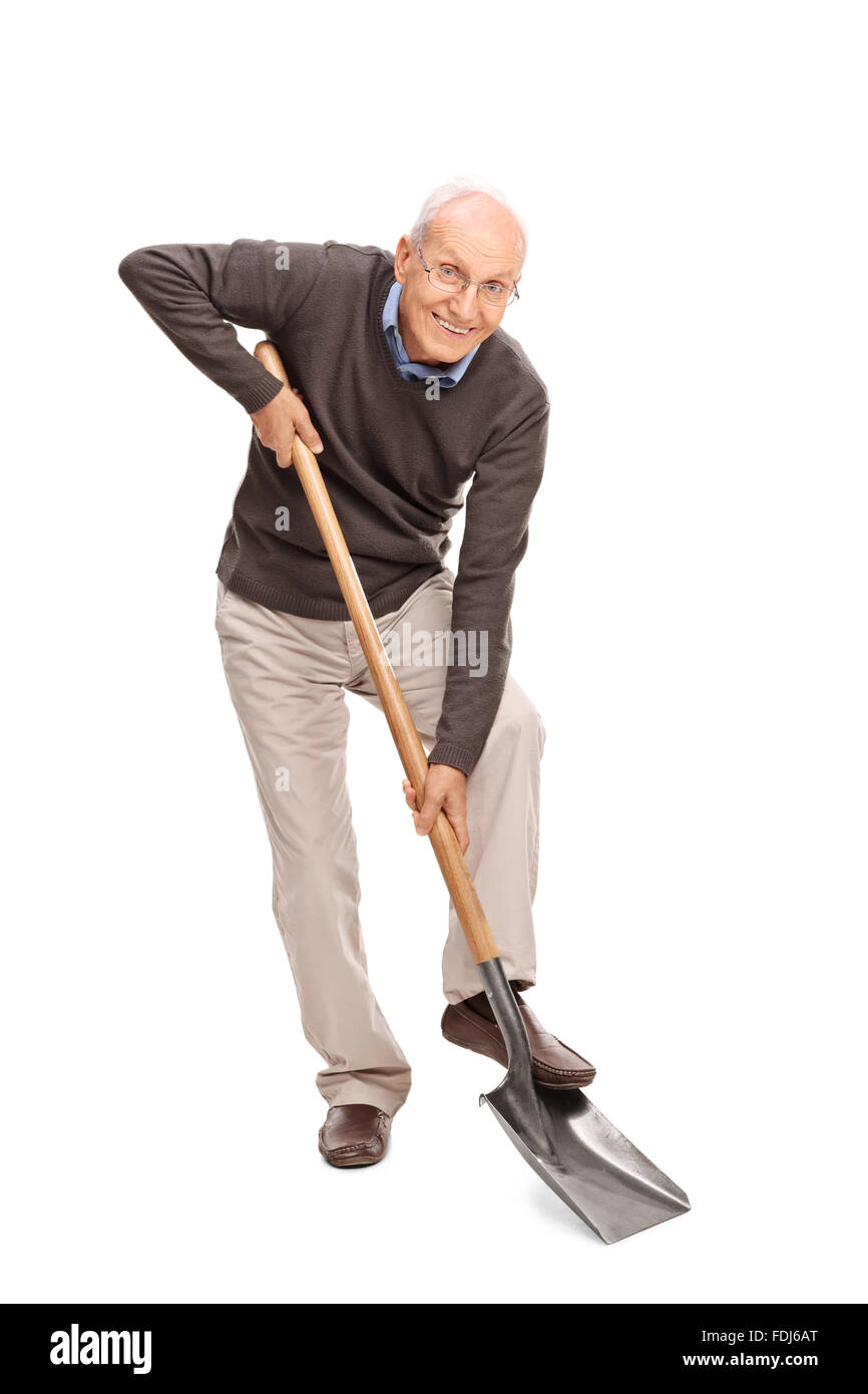 Full length portrait of a senior man digging with a shovel and looking ...