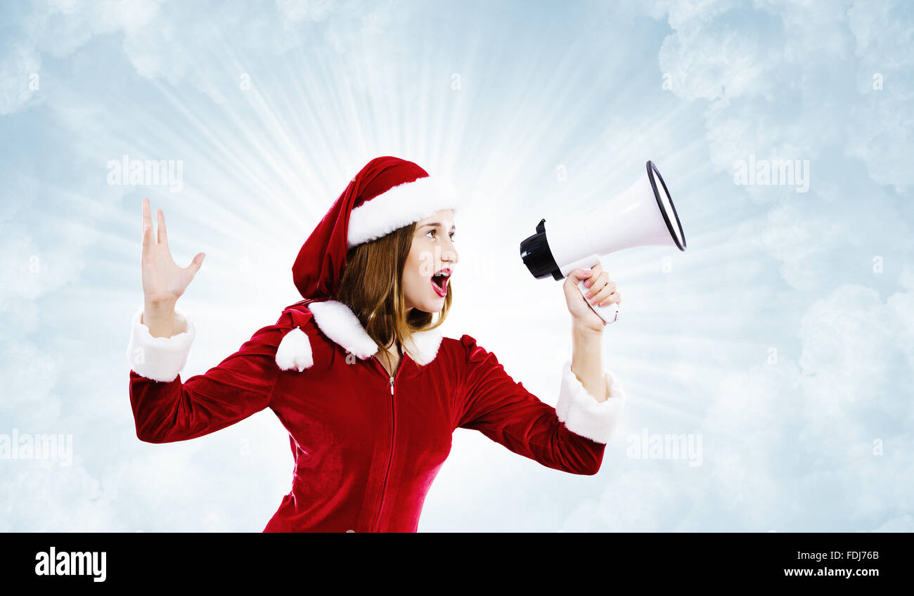 Young attractive Santa girl screaming in megaphone Stock Photo - Alamy