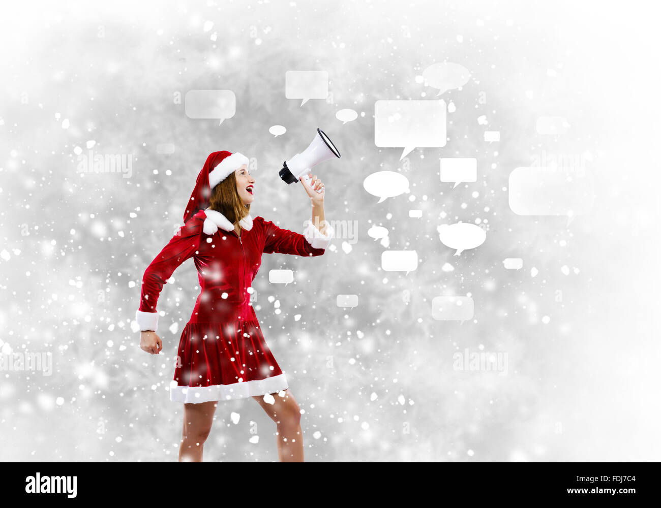 Young attractive Santa girl screaming in megaphone Stock Photo - Alamy