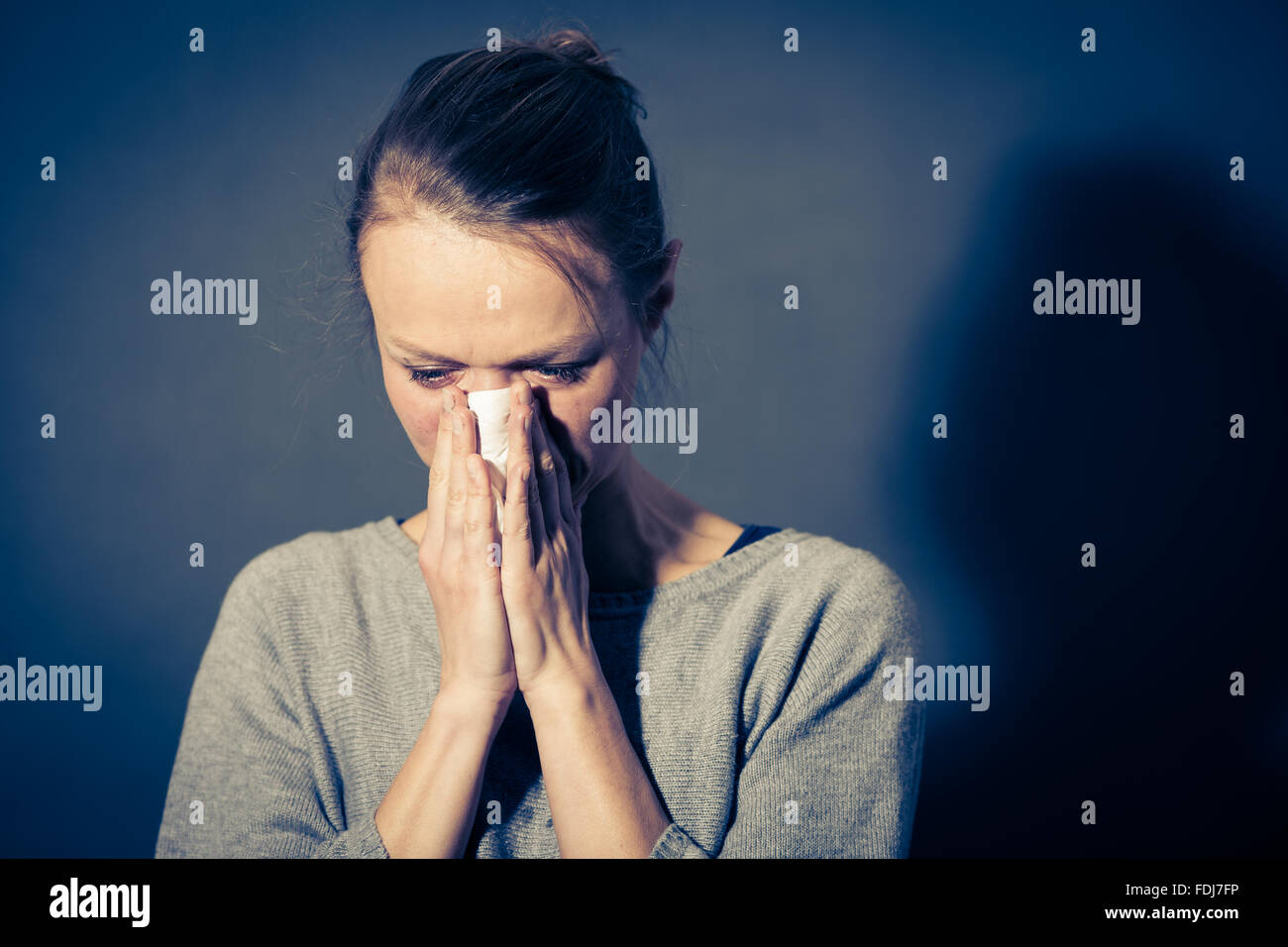 Young woman suffering from severe depression/anxiety/sadness, crying ...
