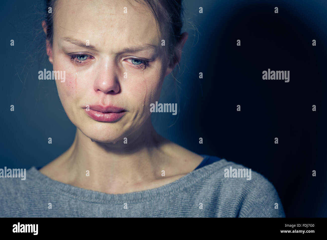 Young woman suffering from severe depression/anxiety/sadness, crying ...