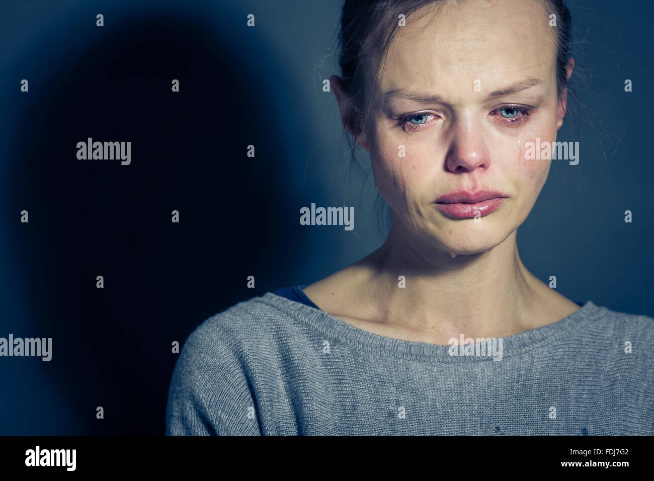 Young woman suffering from severe depression/anxiety/sadness, crying ...
