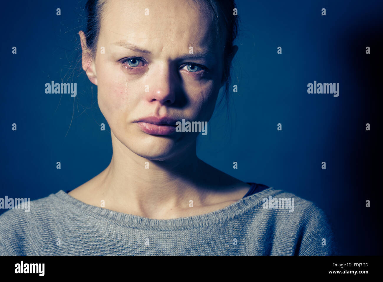 Young woman suffering from severe depression/anxiety/sadness, crying ...