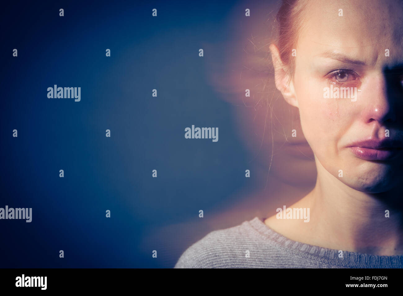 Young woman suffering from severe depression/anxiety/sadness, crying ...