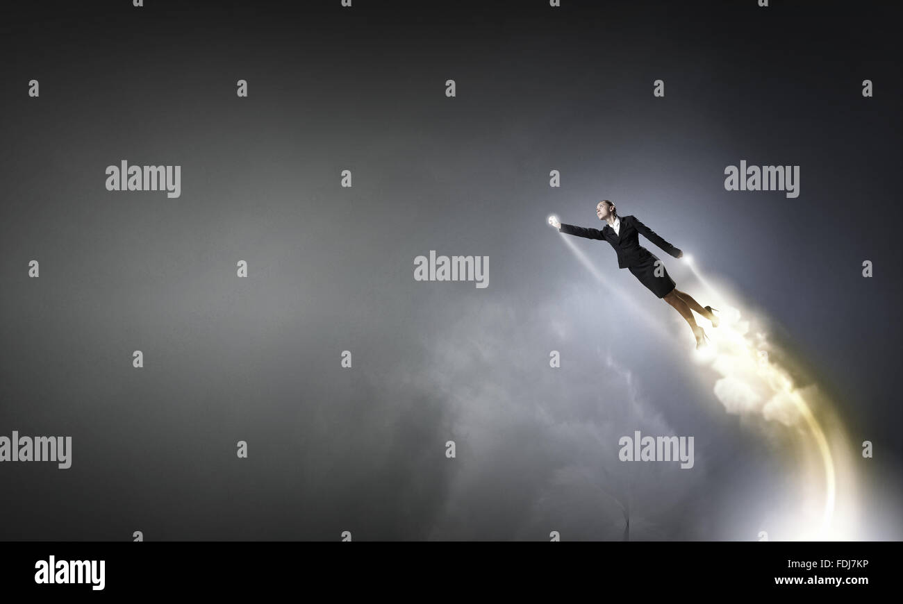 Businesswoman hero in suit flying up into sky Stock Photo - Alamy