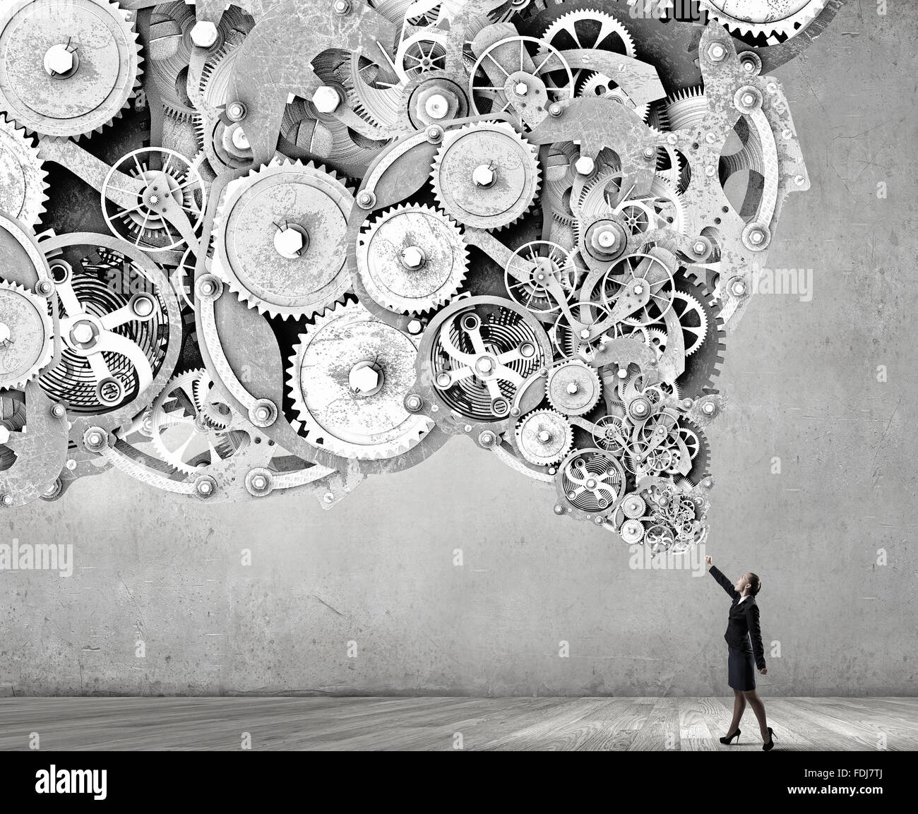 Young businesswoman catching with hand gear and cogwheel mechanism ...