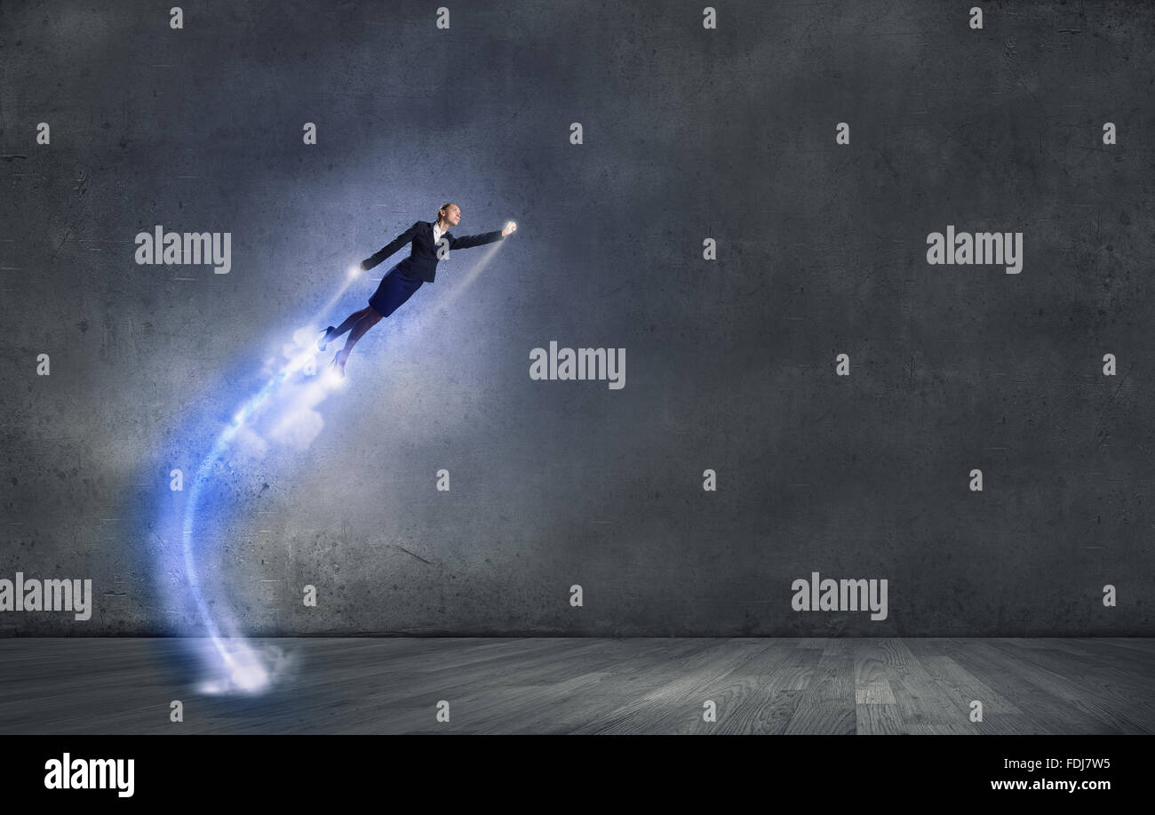 Businesswoman hero in suit flying up into sky Stock Photo - Alamy