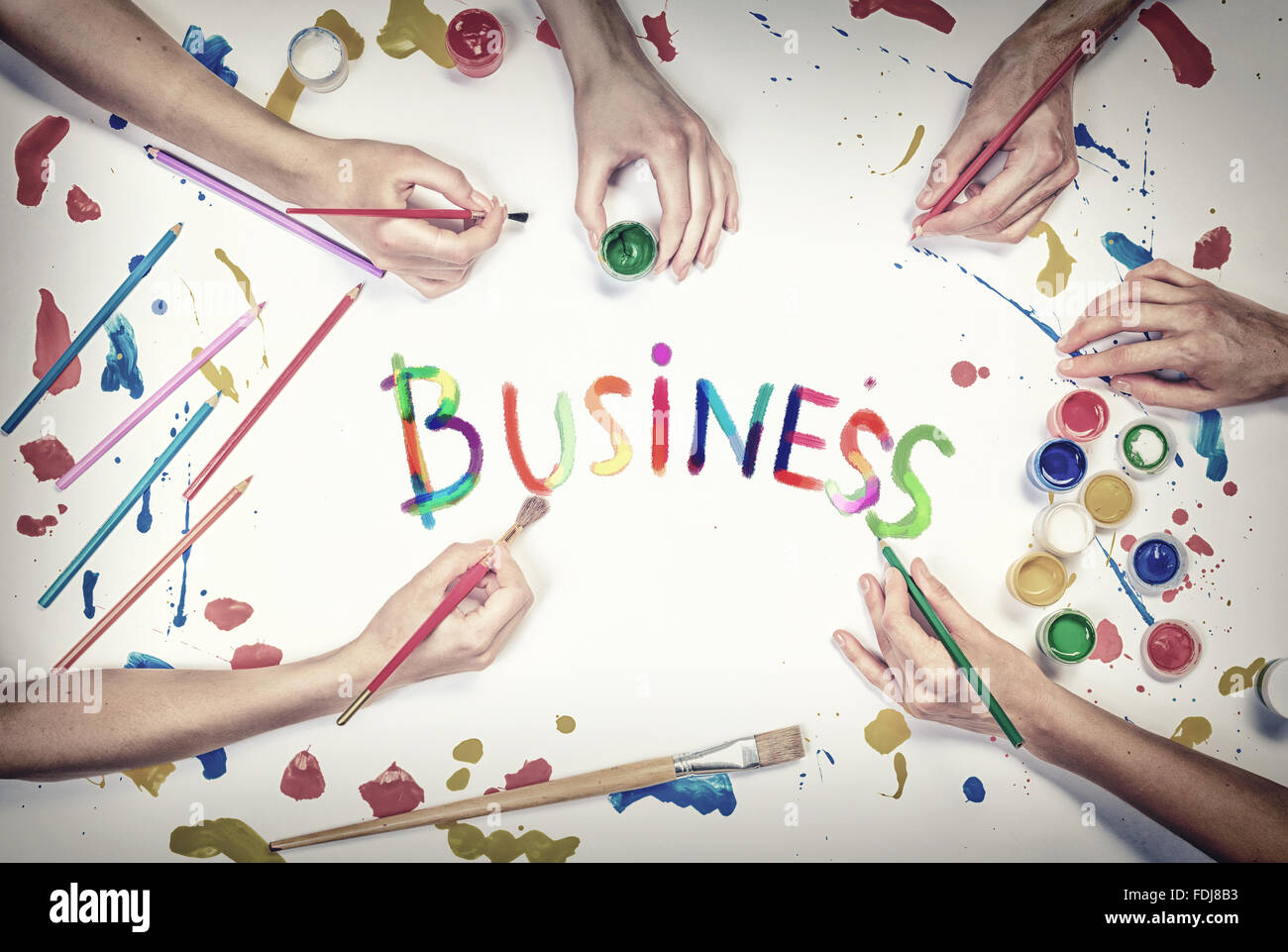 Top view of people hand drawing business creative concept with paints ...