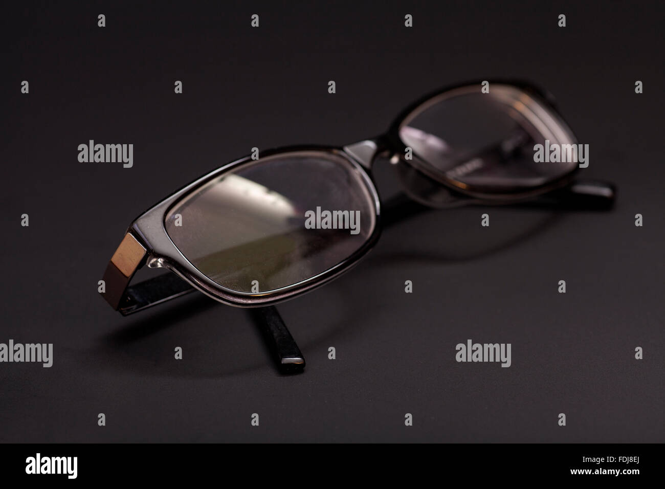 Eyeglasses in a black background Stock Photo - Alamy