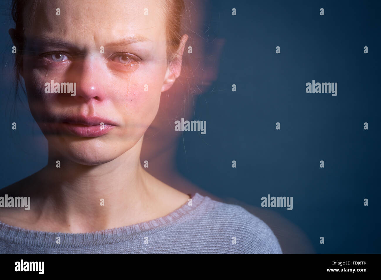 Young woman suffering from severe depression/anxiety/sadness, crying ...