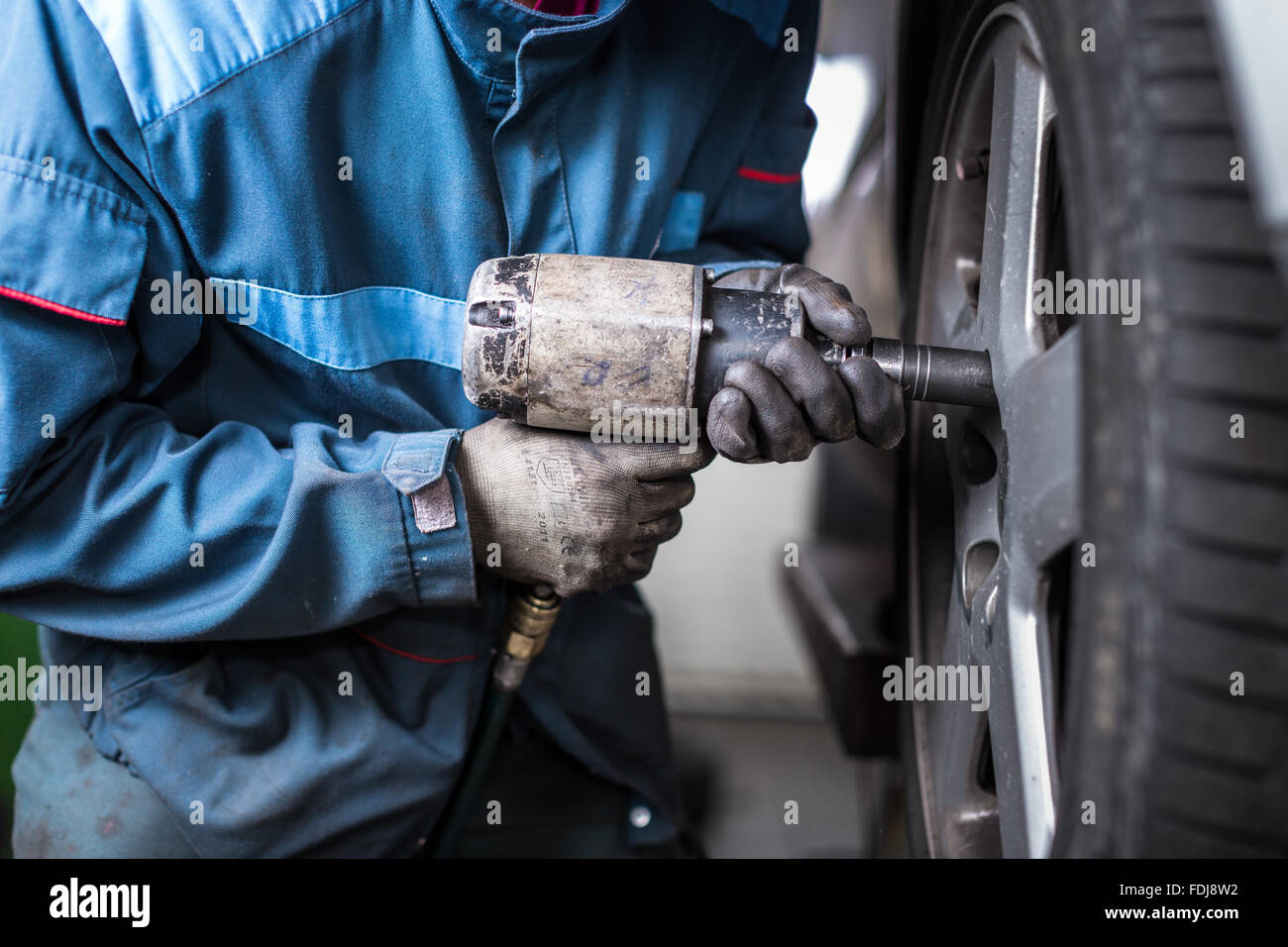 mechanic changing a wheel of a modern car (color toned image Stock ...